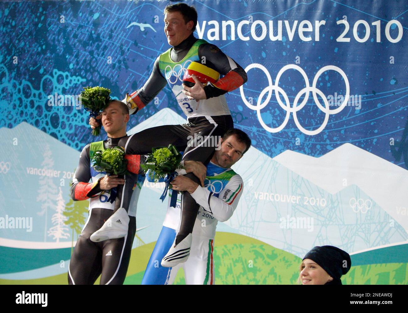 Felix Loch of Germany, center, winner of of the men's singles luge ...