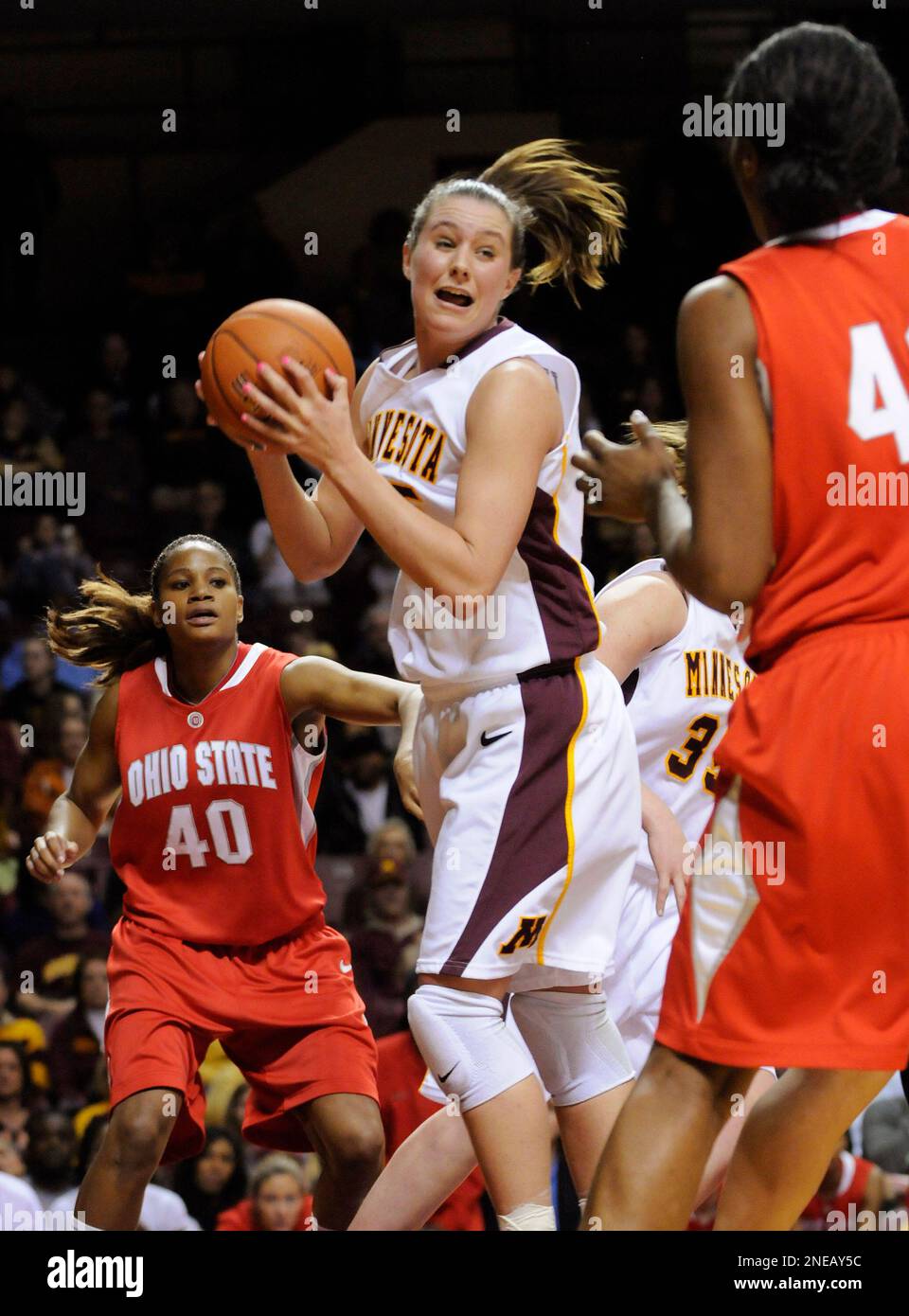 Minnesota's Jackie Voigt, center, grabs a rebound as Ohio State's ...