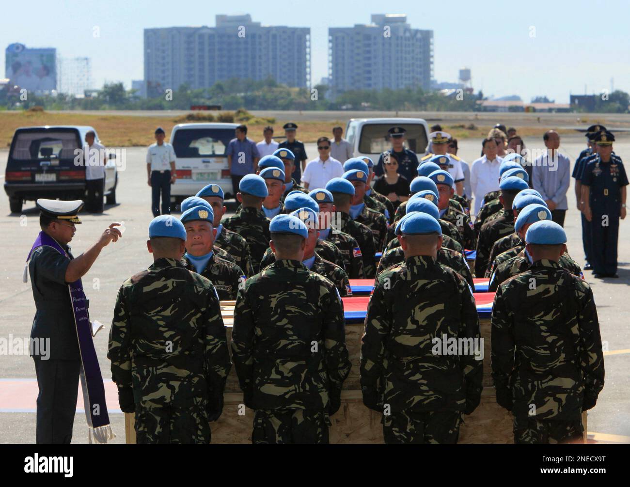 A military chaplain blesses the flag-draped caskets of four Filipino ...