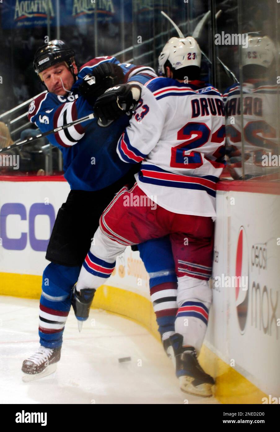 Colorado Avalanche defenseman Adam Foote (52) checks New York Rangers ...