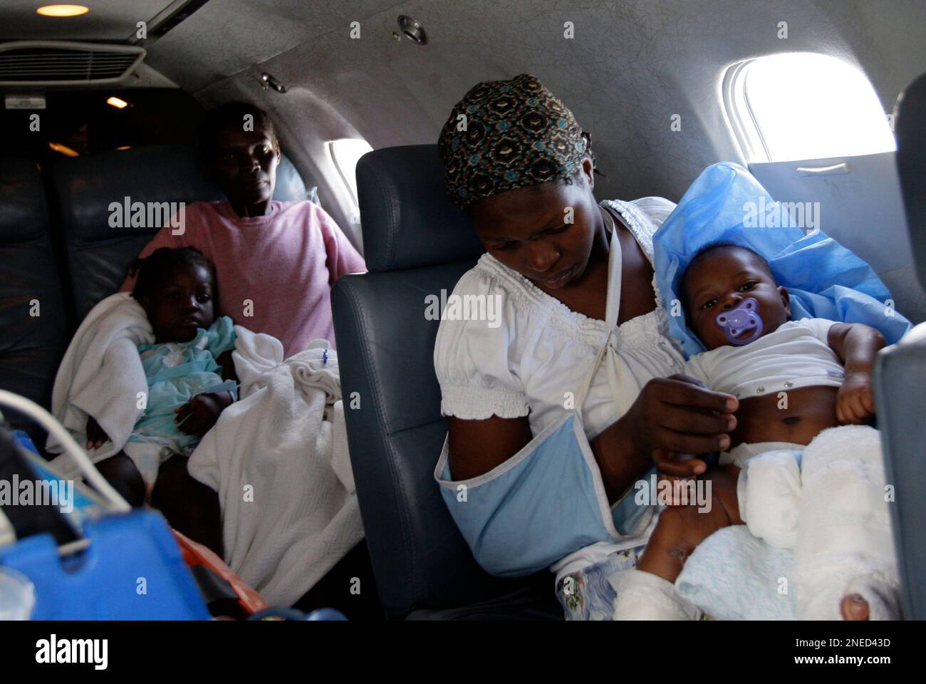 Five-year-old Betina Joseph, far left, sits with her mother Denise ...