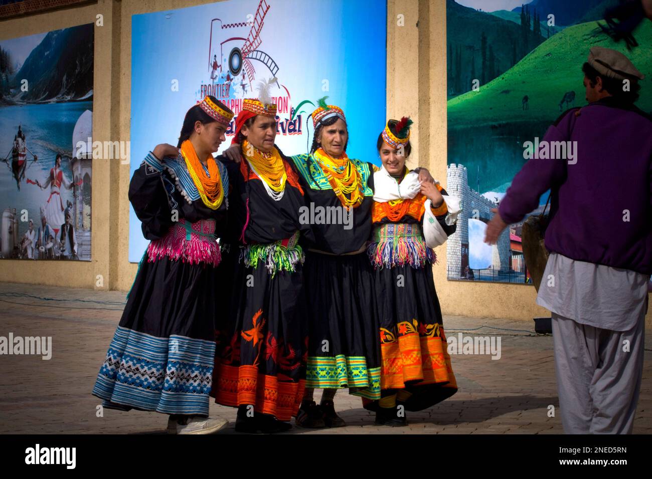 Pakistani women from Kalash tribe in traditional costumes perform a ...