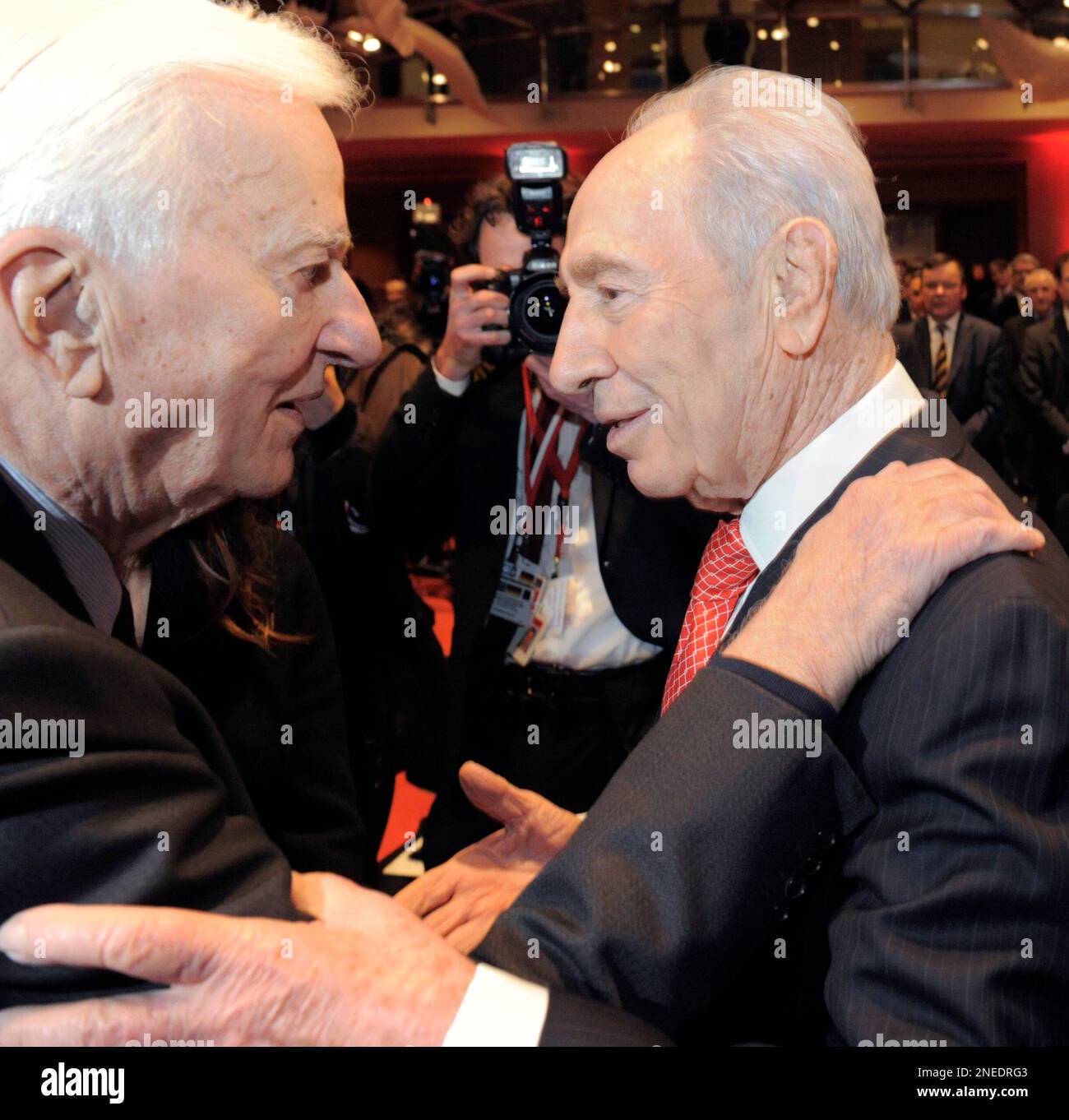 President of Israel Shimon Peres, right, arms the former German ...