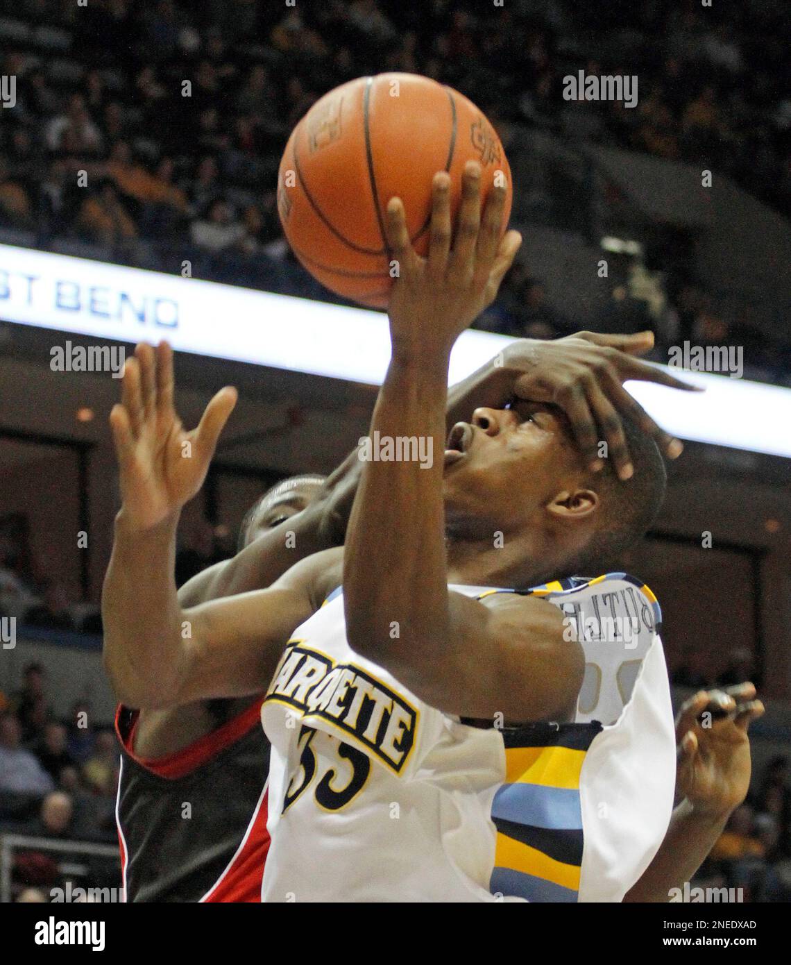 Marquette's Jimmy Butler (33) is fouled by Rutgers' Dane Miller in the ...