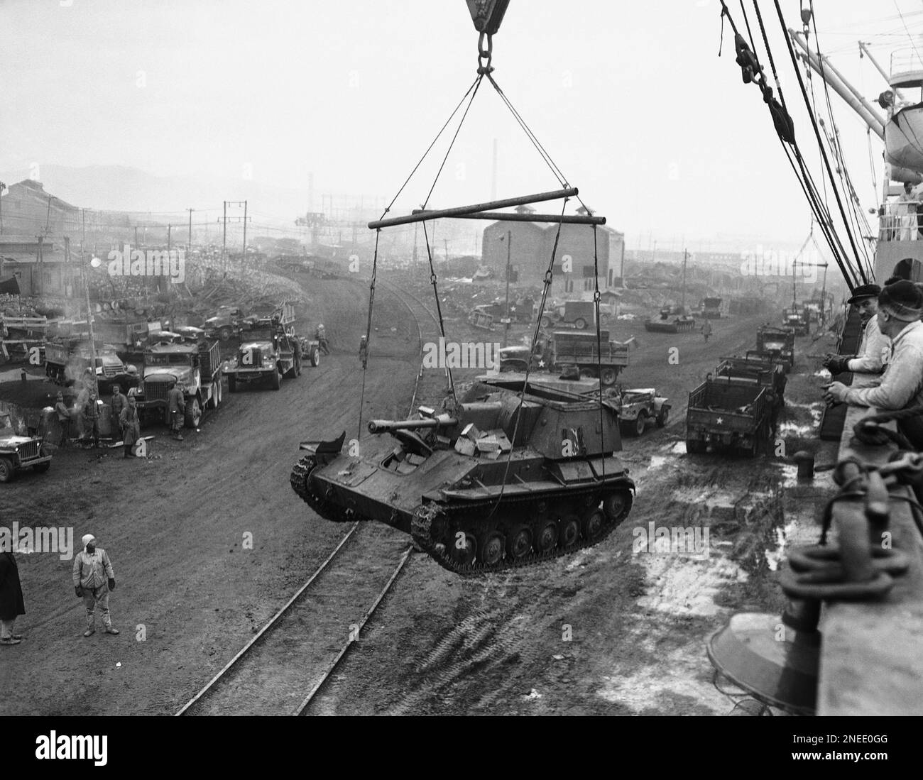 A United Nations tank is swung aboard a ship in Hungnam Harbor ...
