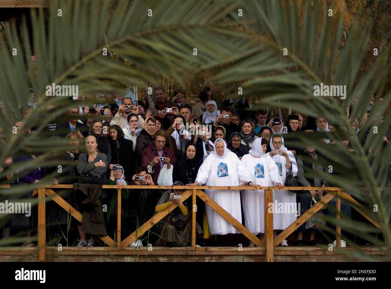 Christian Orthodox pilgrims stand on the Jordanian side of the Jordan ...