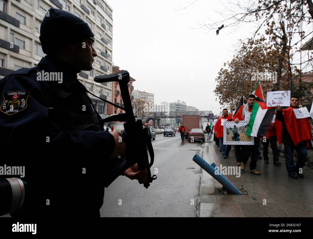 A riot police member watches as members of an Islamic human rights ...