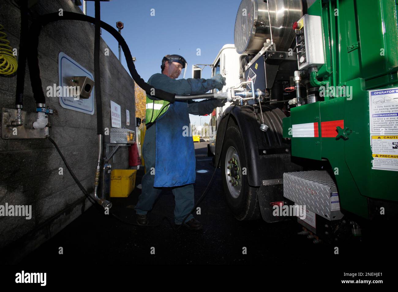 Mike Keele pumps liquid natural gas onto a garbage truck at the Waste ...