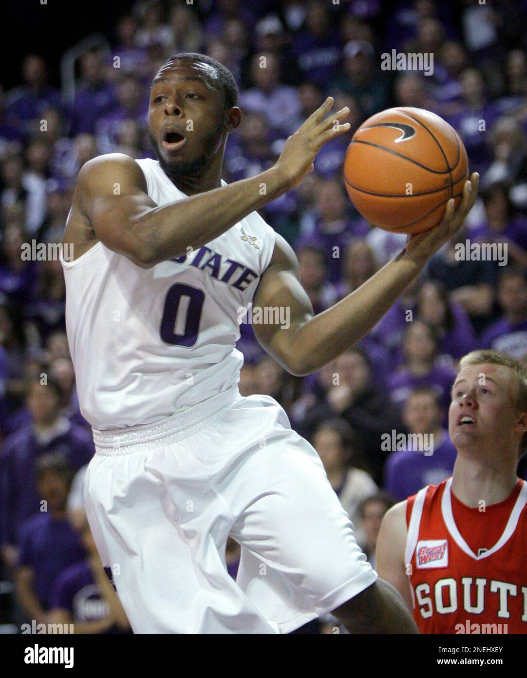 Kansas State's Jacob Pullen (0) gets past South Dakota's Louie Krogman, right, to shoot during ...