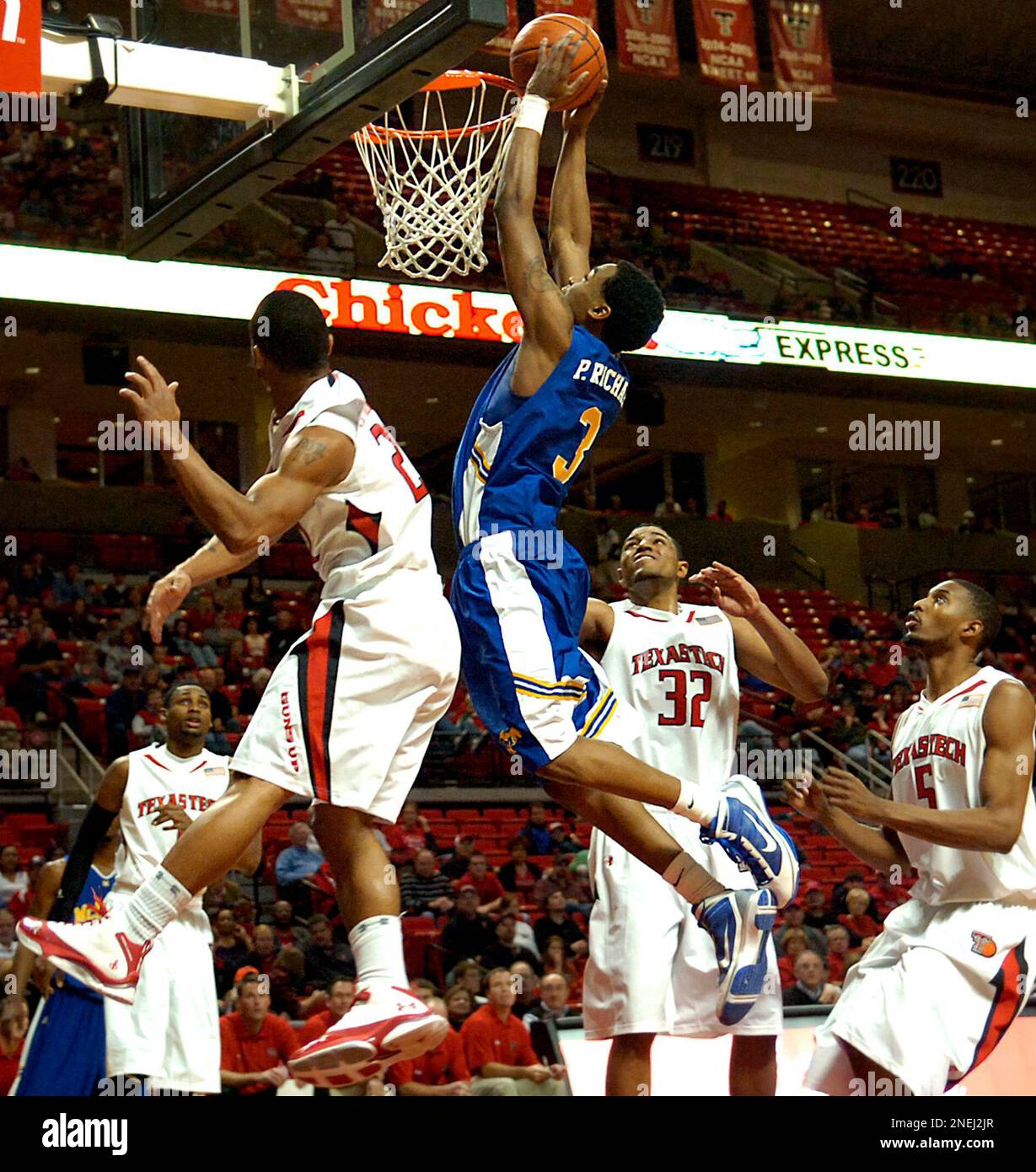 McNeese State's Patrick Richard scores over Texas Tech's John Roberson ...