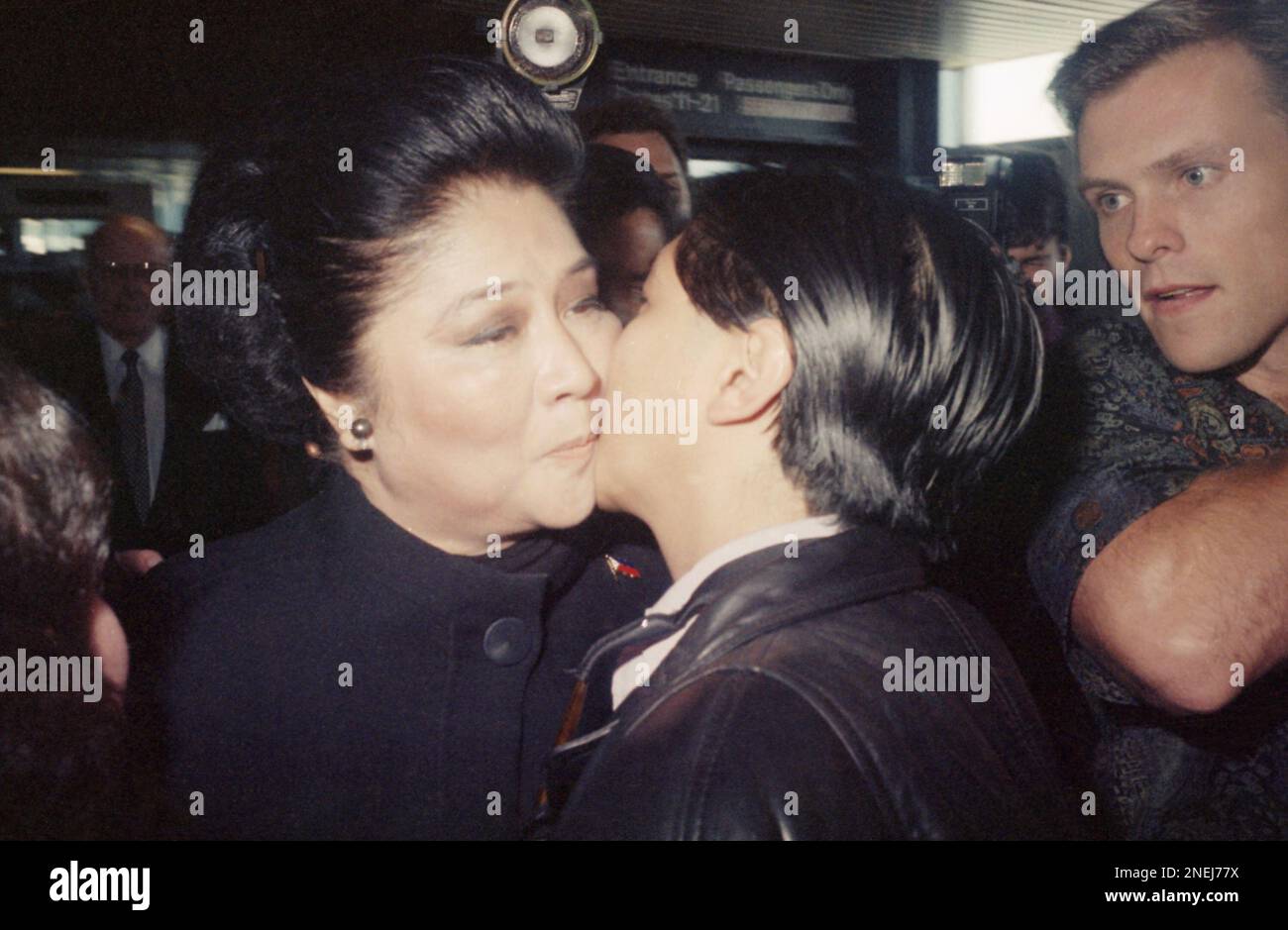 Imelda Marcos gets a kiss from her son, Ferdinand II, on arrival at New ...