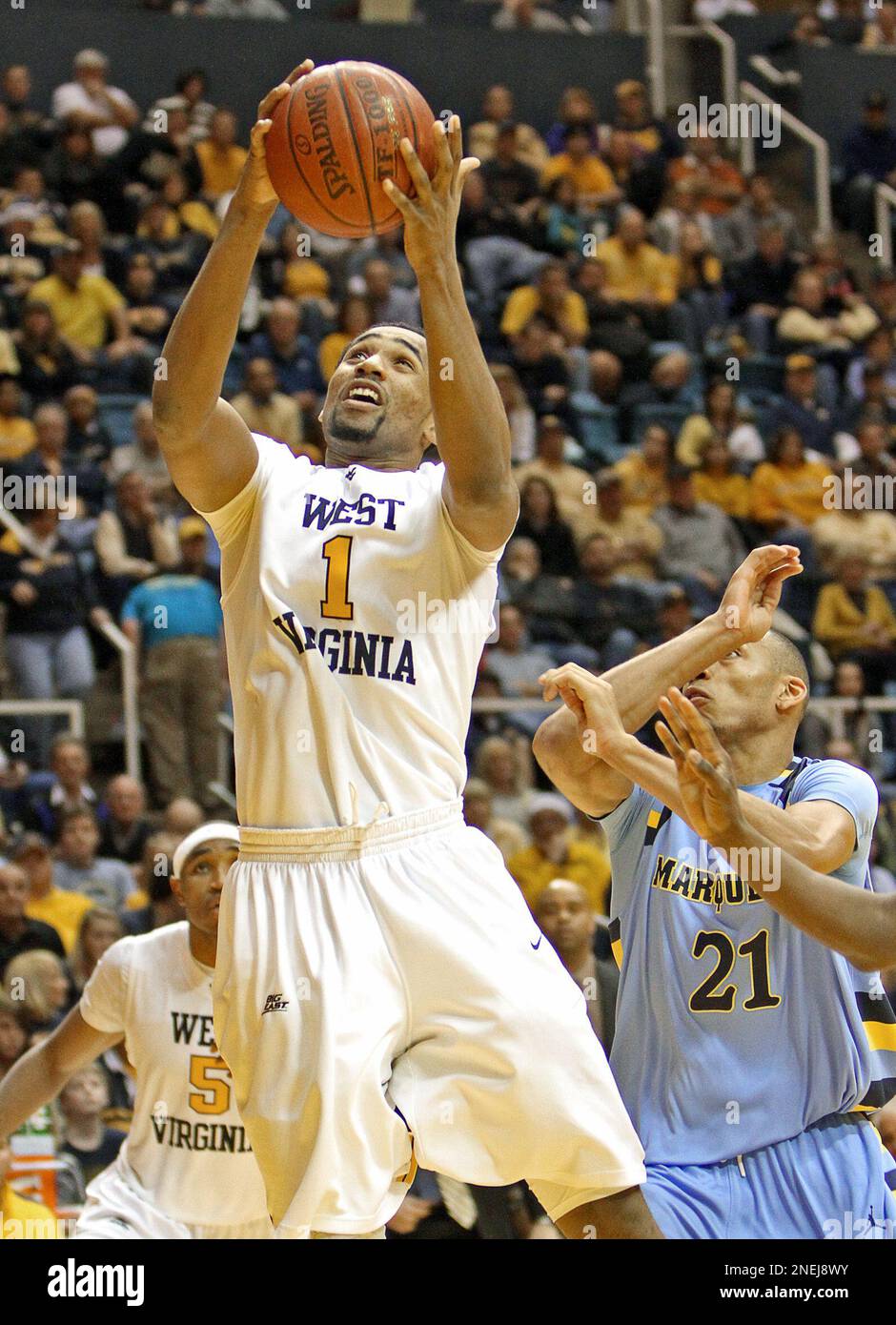 West Virginia's Da'Sean Butler goes up for a layup against Marquette's ...