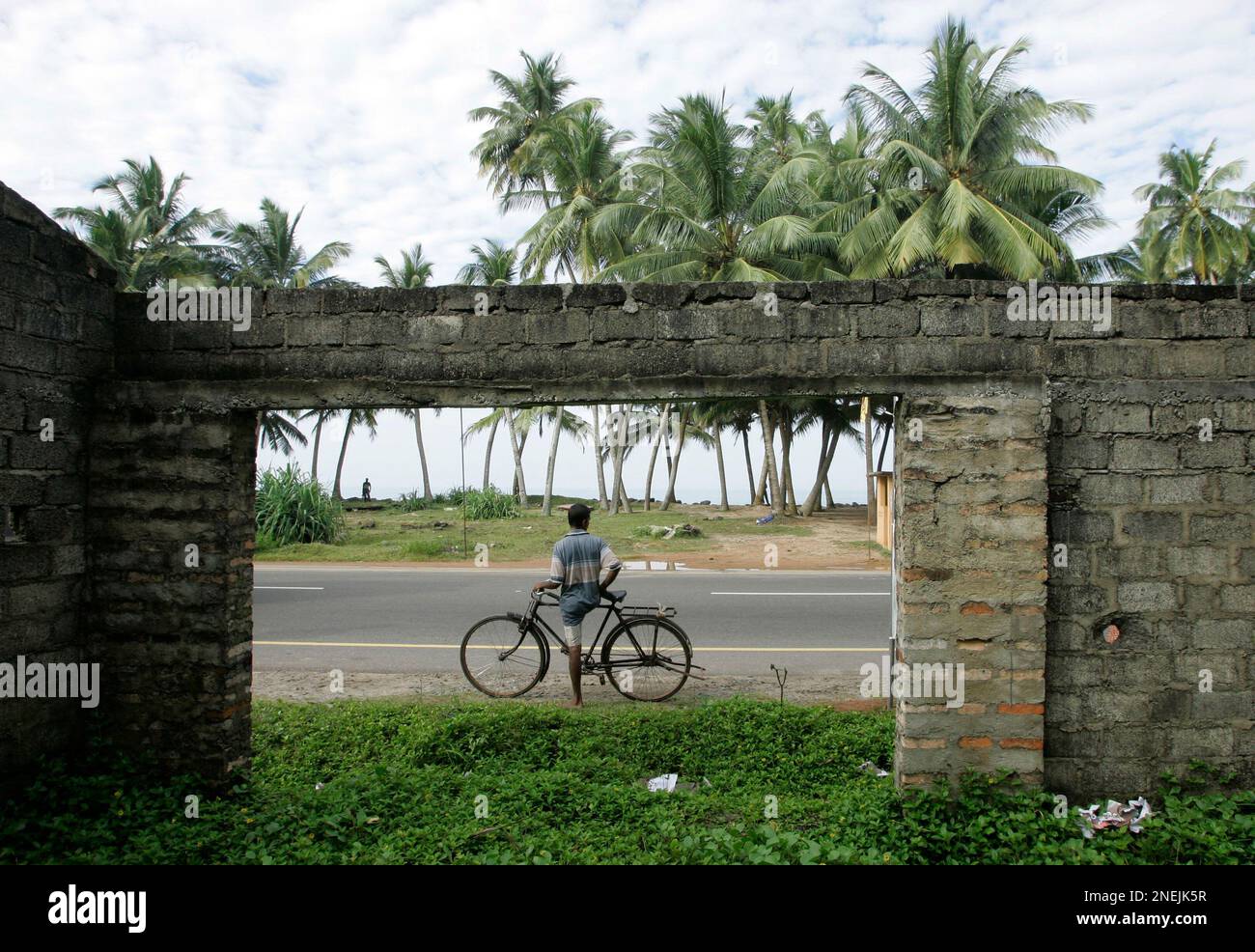 A Sri Lankan tsunami survivor is seen through a destroyed house on the ...