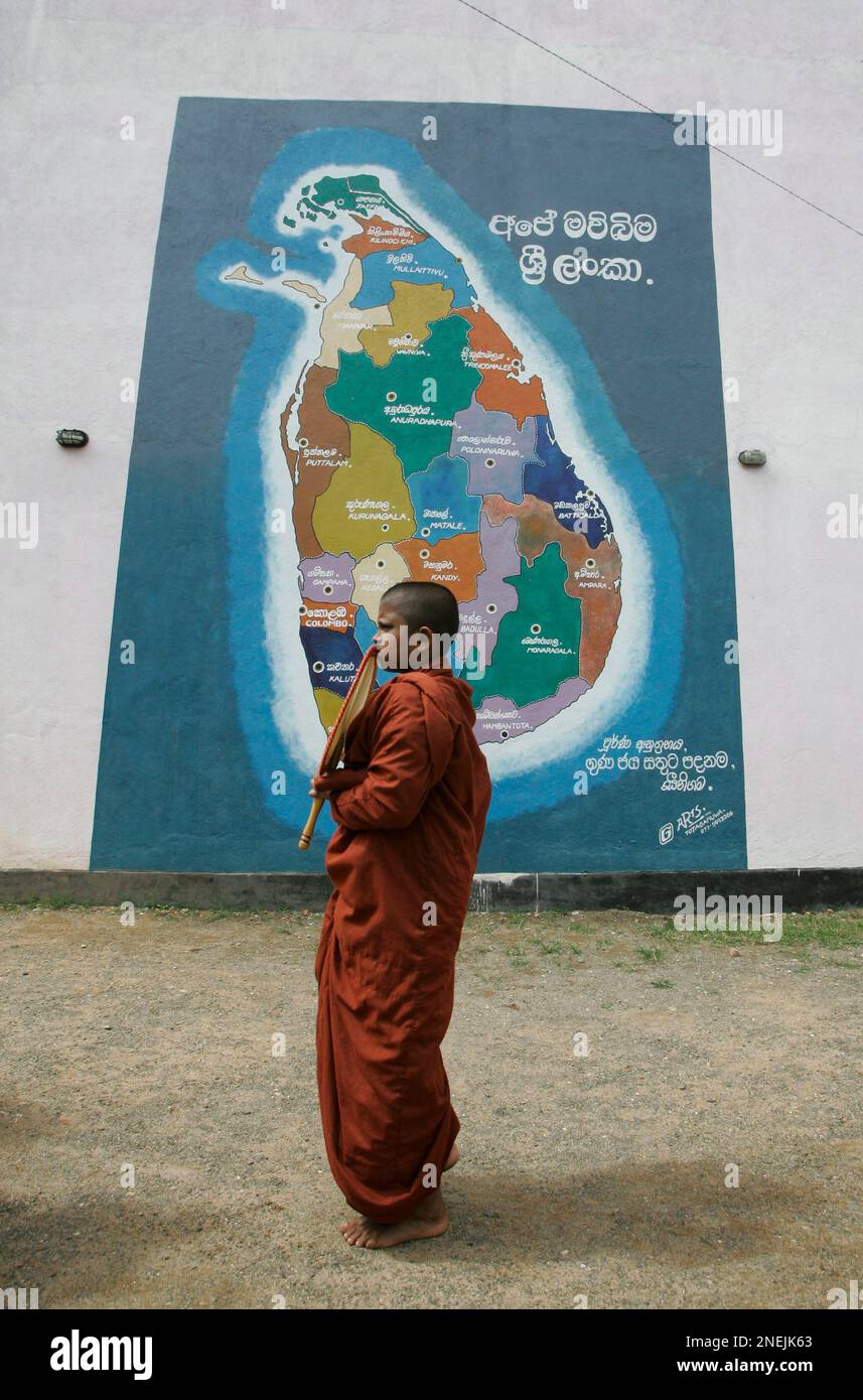 A Sri Lankan Buddhist Monk Walks Past Sri Lanka s Map As He Arrives At a-sri-lankan-buddhist-monk-walks-past-sri-lanka-s-map-as-he-arrives-at