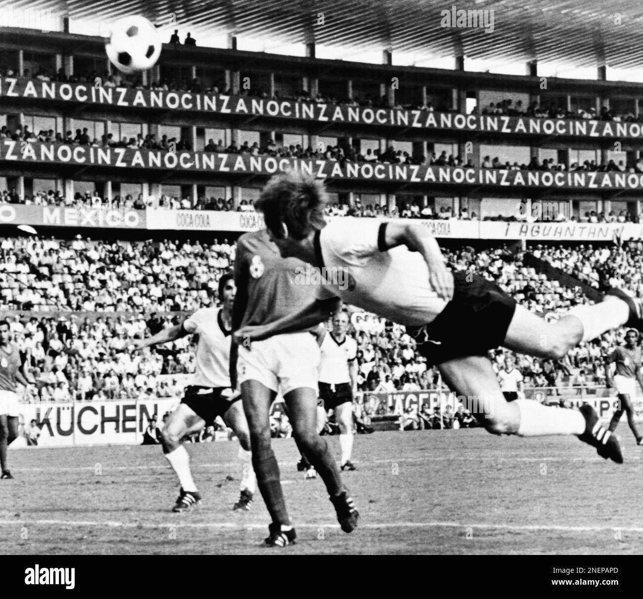 West Germany's Hennes Loehr, heads a ball to Gerd Mueller, second from ...