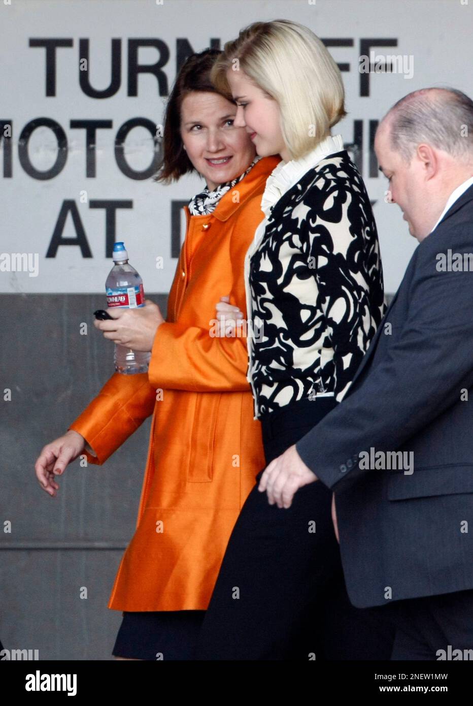 Elizabeth Smart (center) and her mother Lois Smart (left) are escorted ...