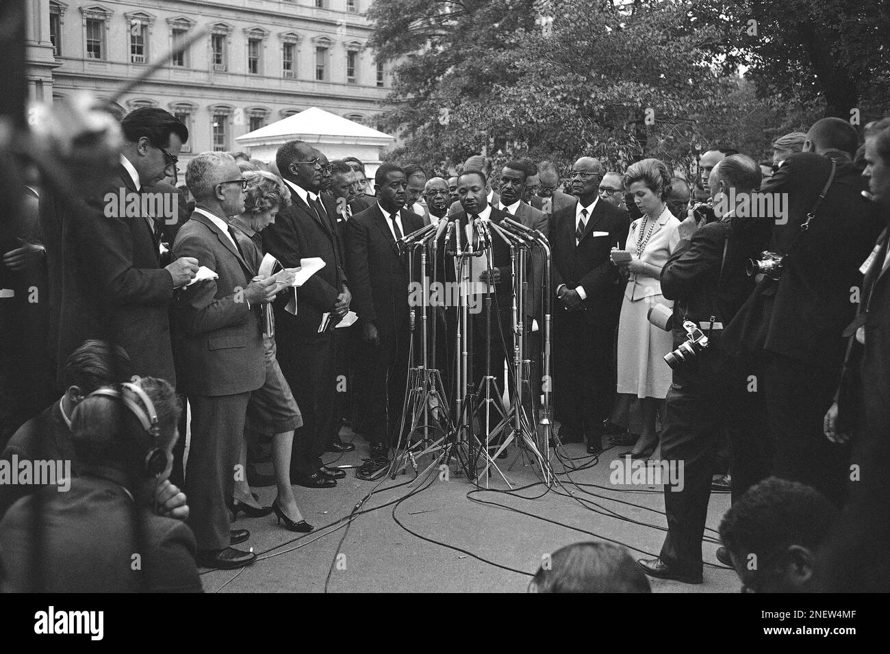 Newsmen hem in African American leaders after they emerged from an hour ...