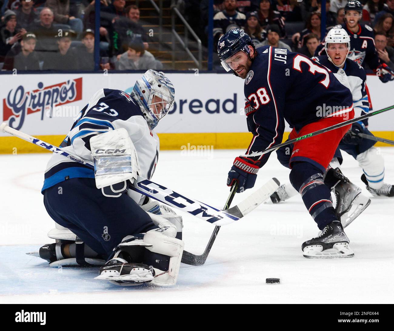 Winnipeg Jets goalie David Rittich, left, stops a shot in front of ...