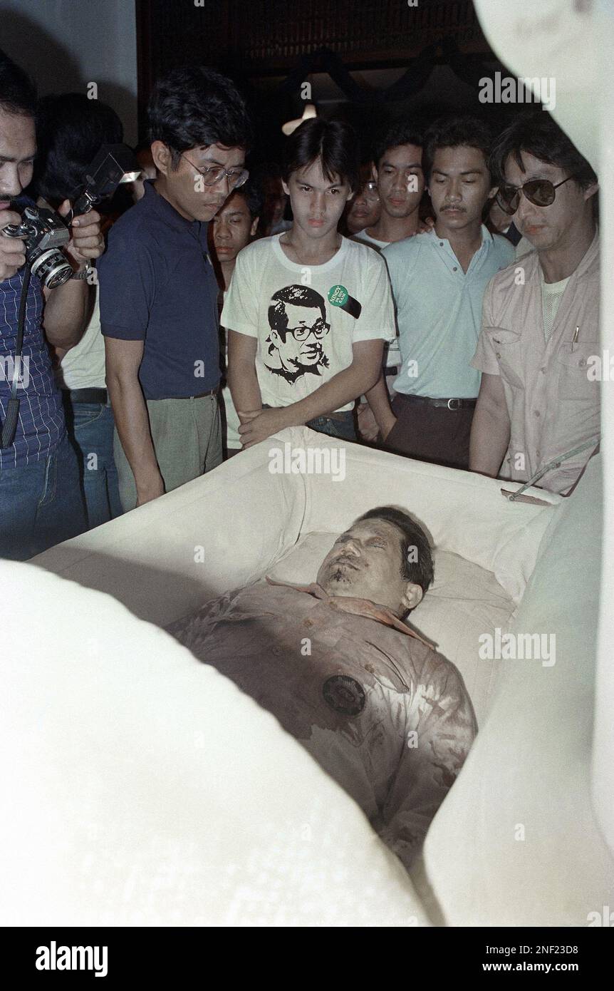 Former Senator Benigno Aquino’s body lay in a casket after being shot ...