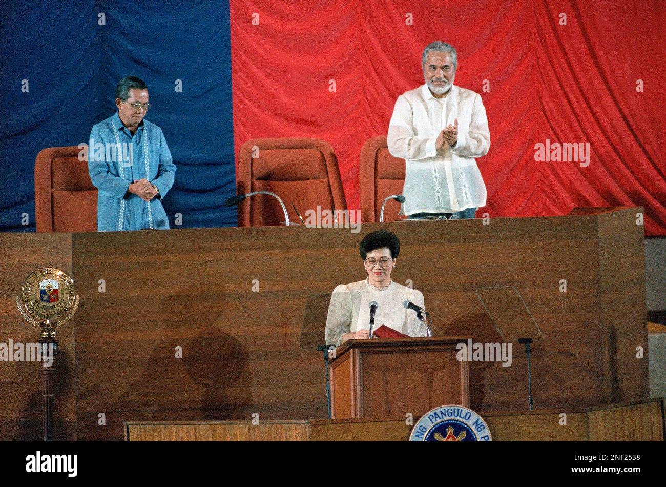 Philippine President Corazon Aquino, at podium, receives applause from ...