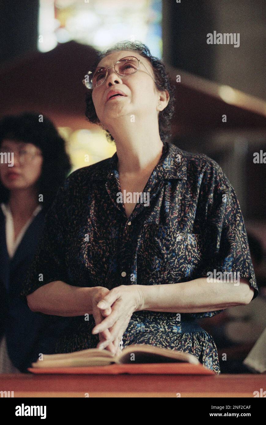 Sinfrosa Uremia looks skyward as she prays for the victims of the massive earthquake which hit ...