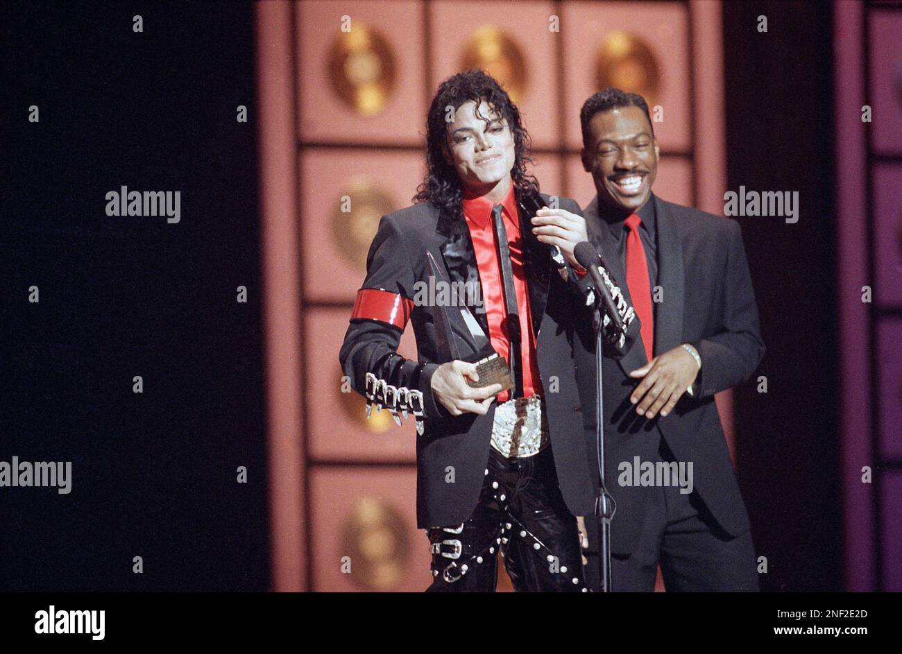 Entertainer Eddie Murphy, right, jokes with Michael Jackson as Jackson ...