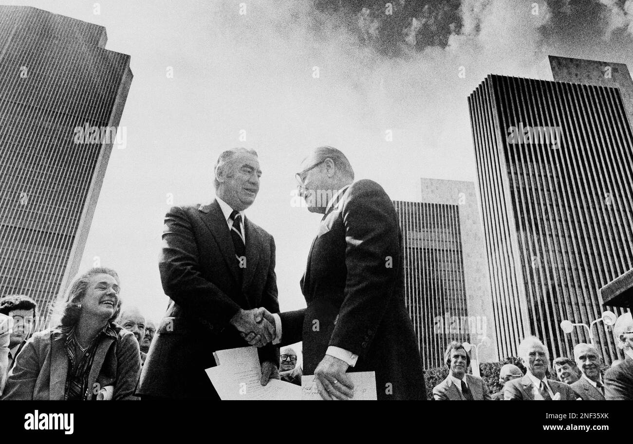 While Happy Rockefeller, left, smiles, New York Gov. Hugh Carey shakes ...