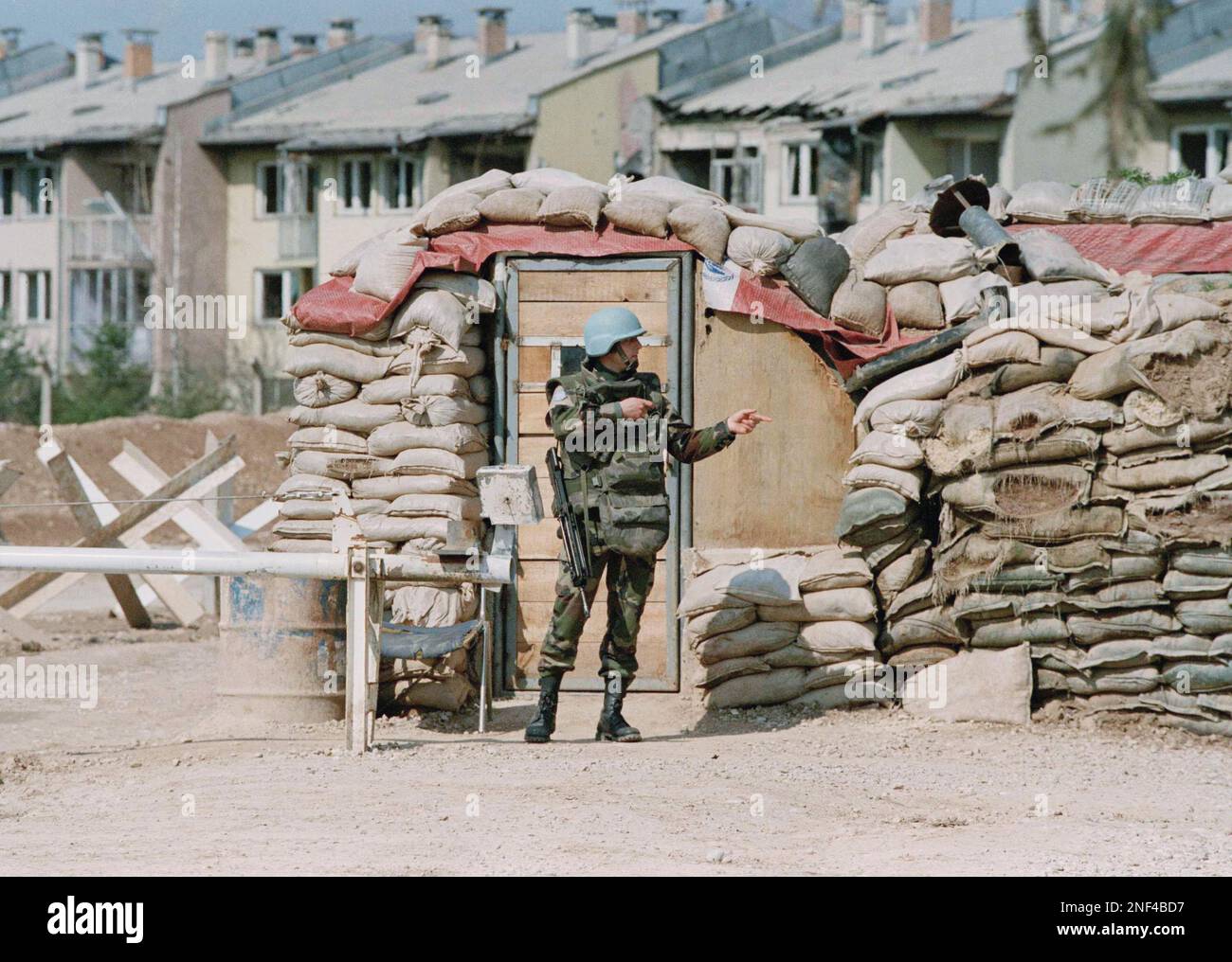 A French United Nations soldier gestures to a comrade that snipers are ...