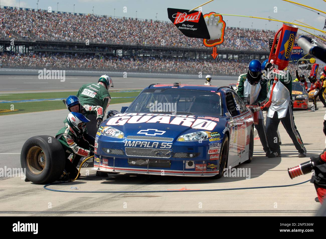 Dale Earnhardt Jr.'s crew works to get him back on the track during a ...