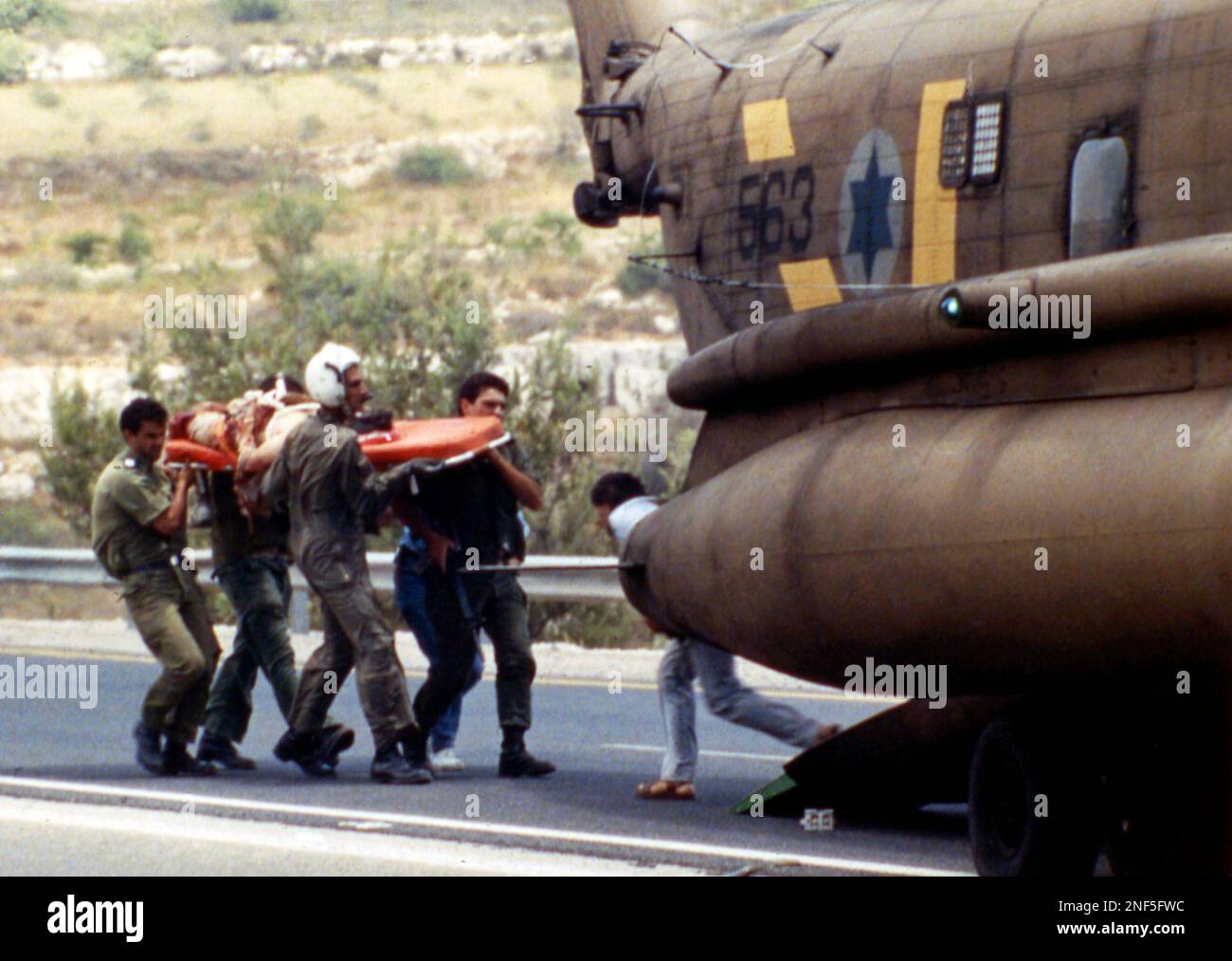 Soldiers carry an injured bus passenger toward a waiting helicopter in ...