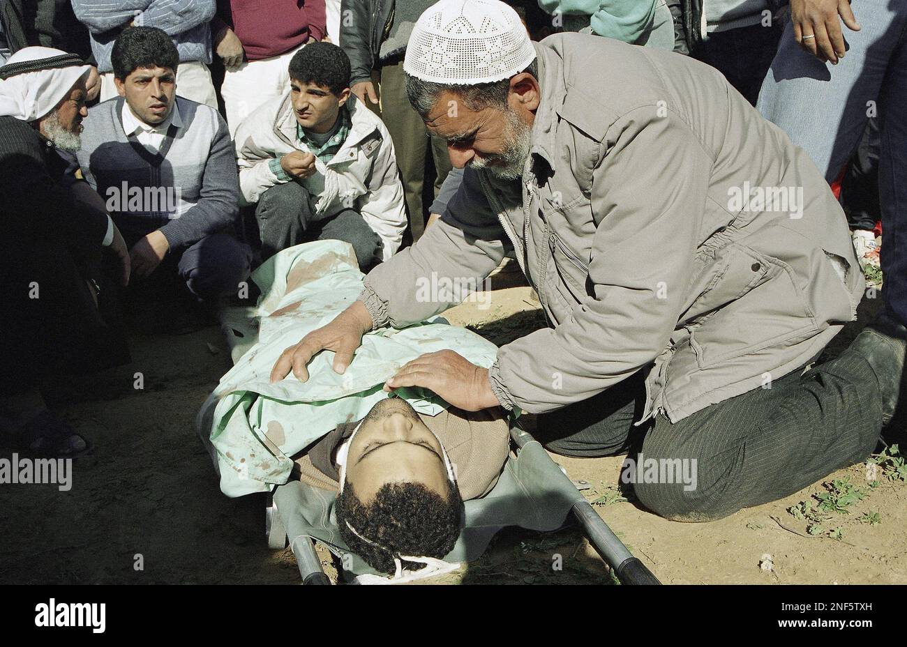 The father of Muhammad Abu Abdo mourns over the body of his dead son in ...