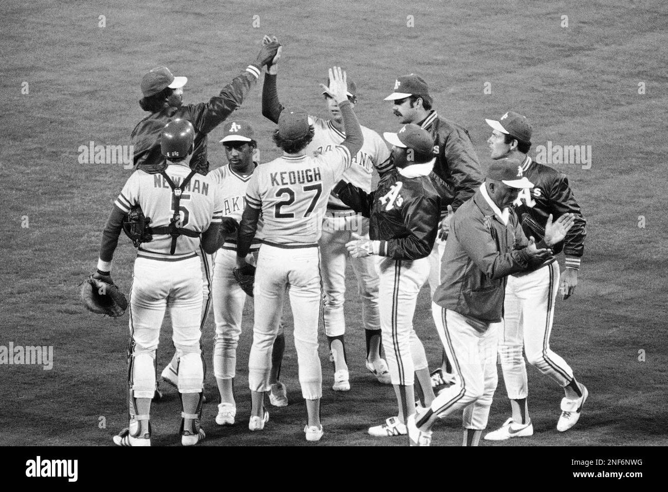 Members of the Oakland As congratulate each other after defeating the ...