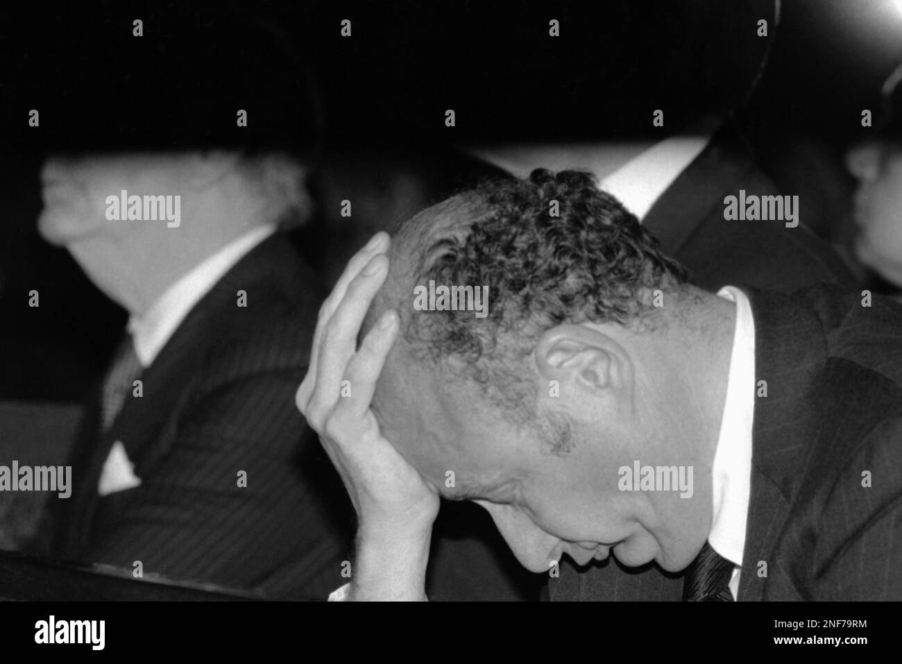 Mayor Edward Koch of New York City holds his bowed head during a ...