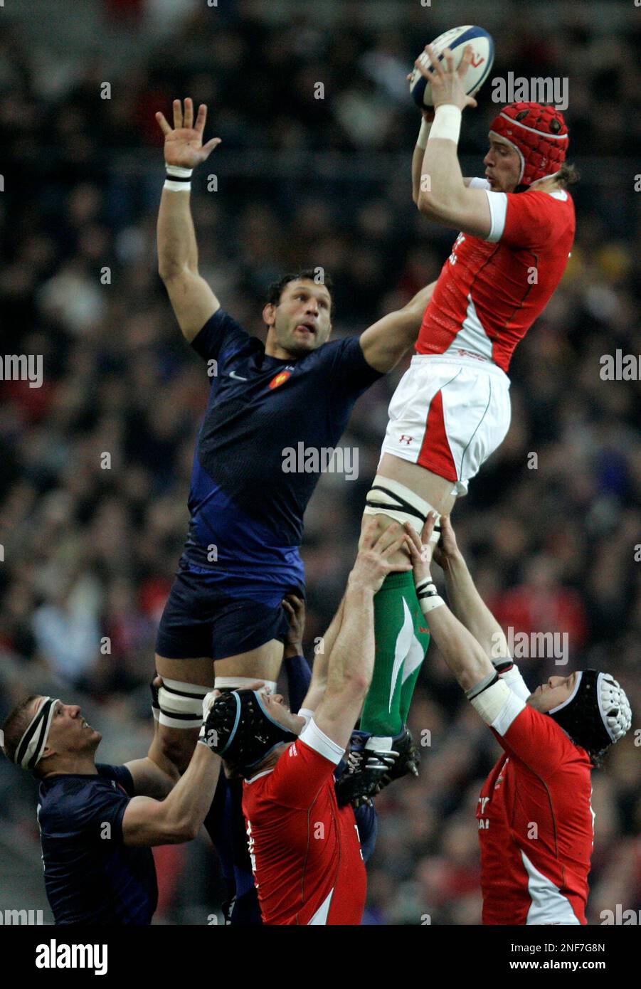 Wales' Alun Wyn Jones, right, catches the ball challenged by France's ...