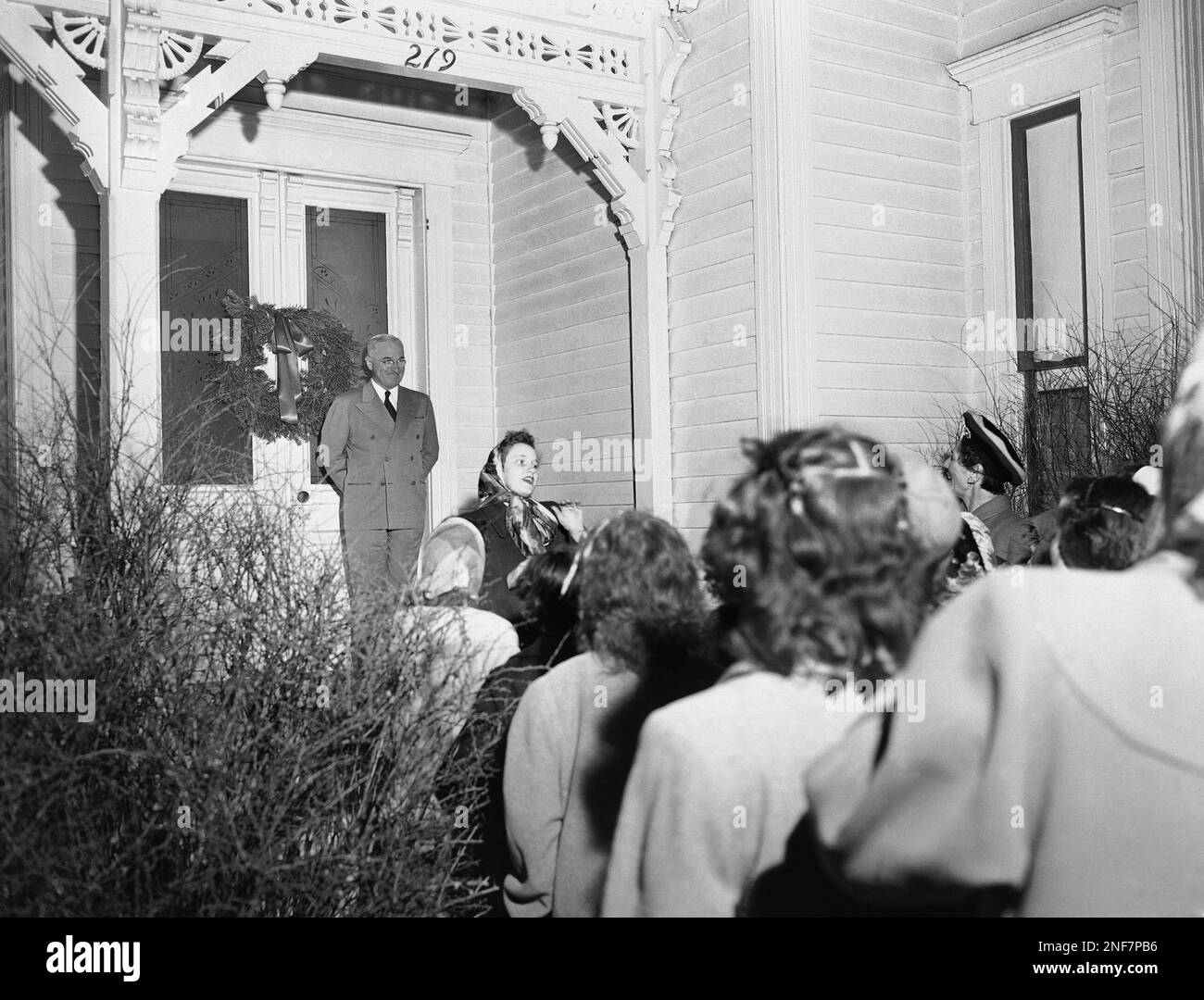 A smiling President Harry S. Truman stands on porch of home at ...