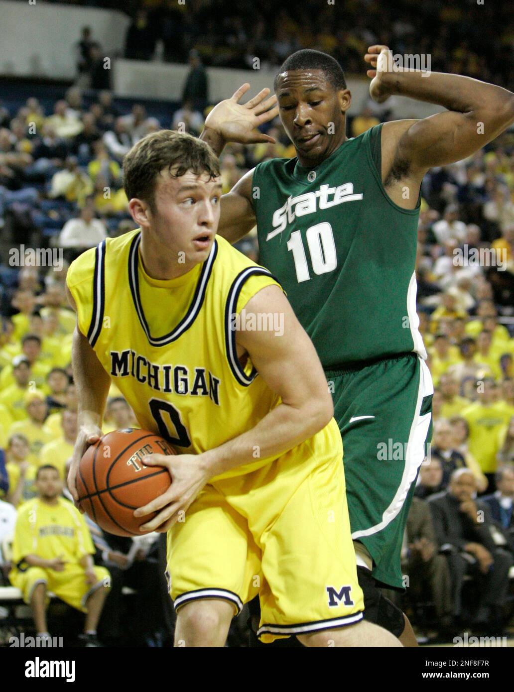 Michigan guard Zack Novak (0) is guarded by Michigan State forward ...