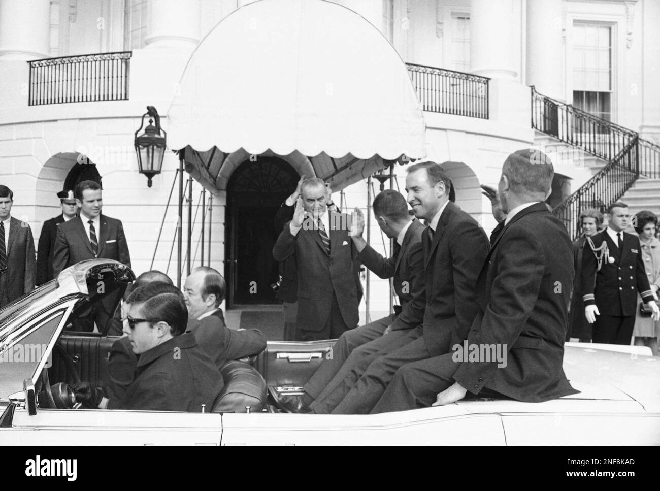 President Lyndon Johnson salutes the three Apollo 8 astronauts as they ...
