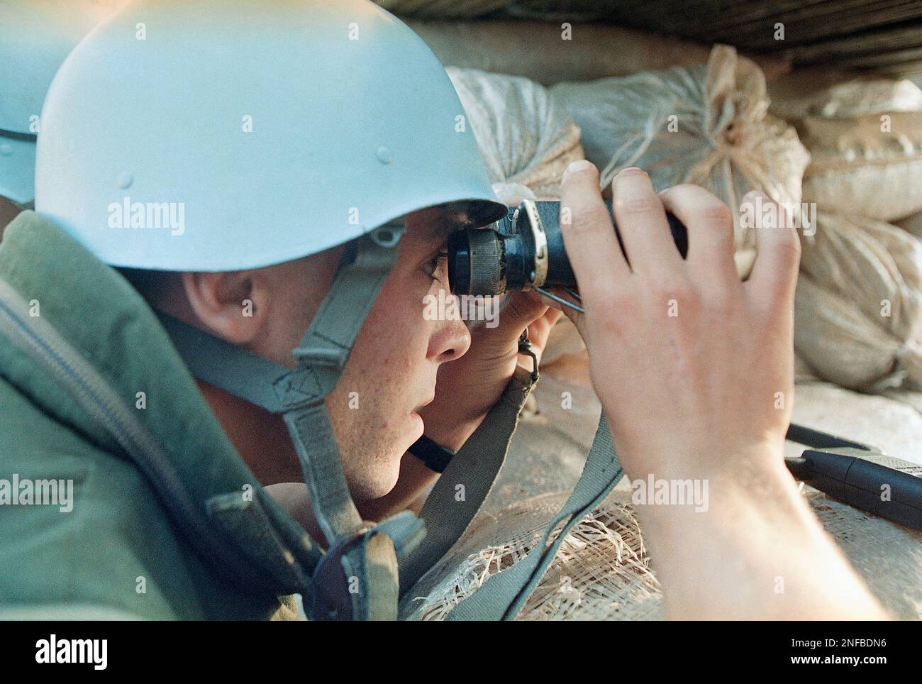 A French United Nations Protection Forces (UNPF) soldier, behind ...