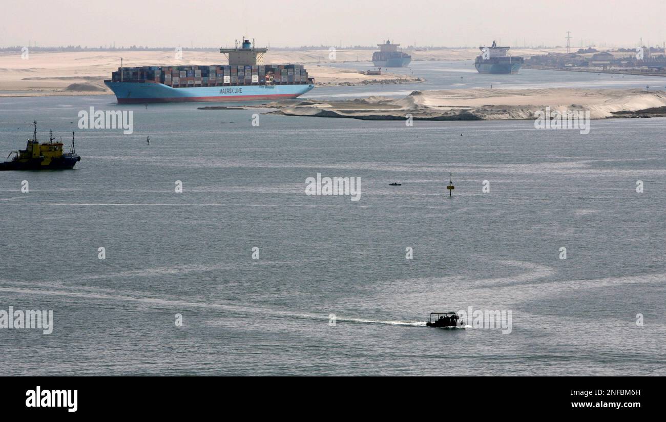 Cargo ships are seen going through the Suez Canal towards the Red Sea ...
