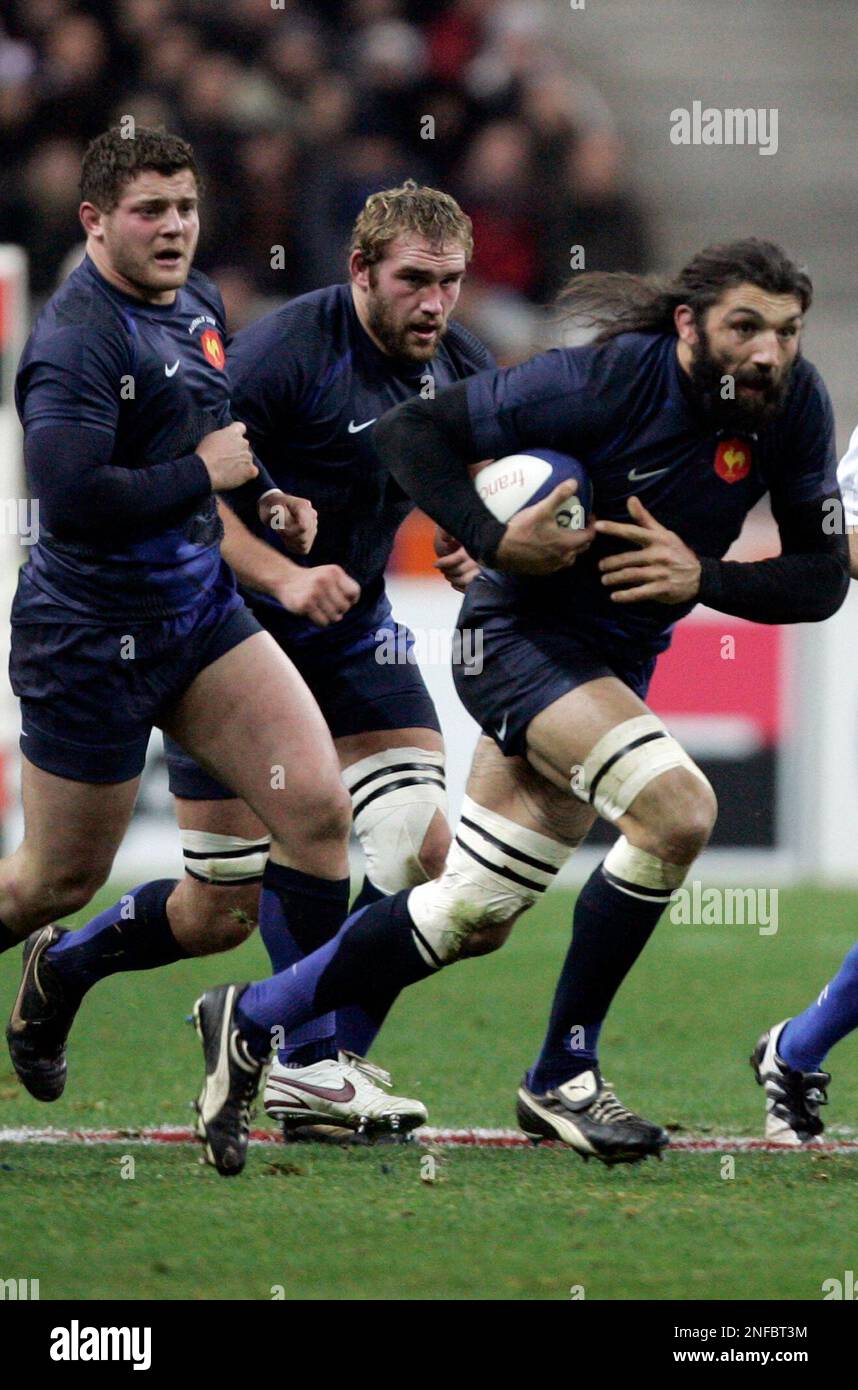 France's Sebastien Chabal, right, runs with the ball followed by ...
