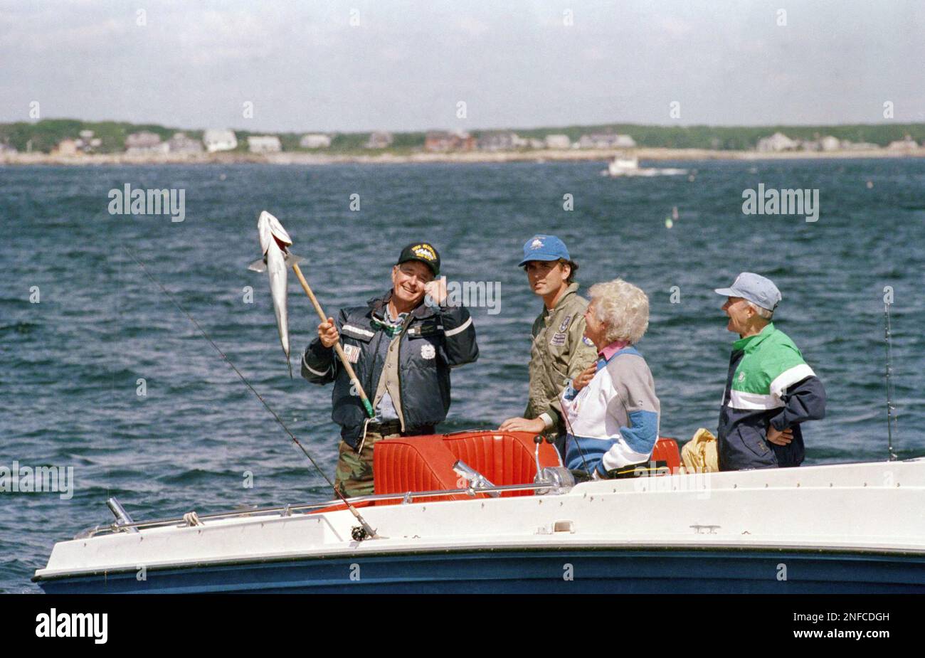 President George Bush beams with pride as he holds up a bluefish he ...