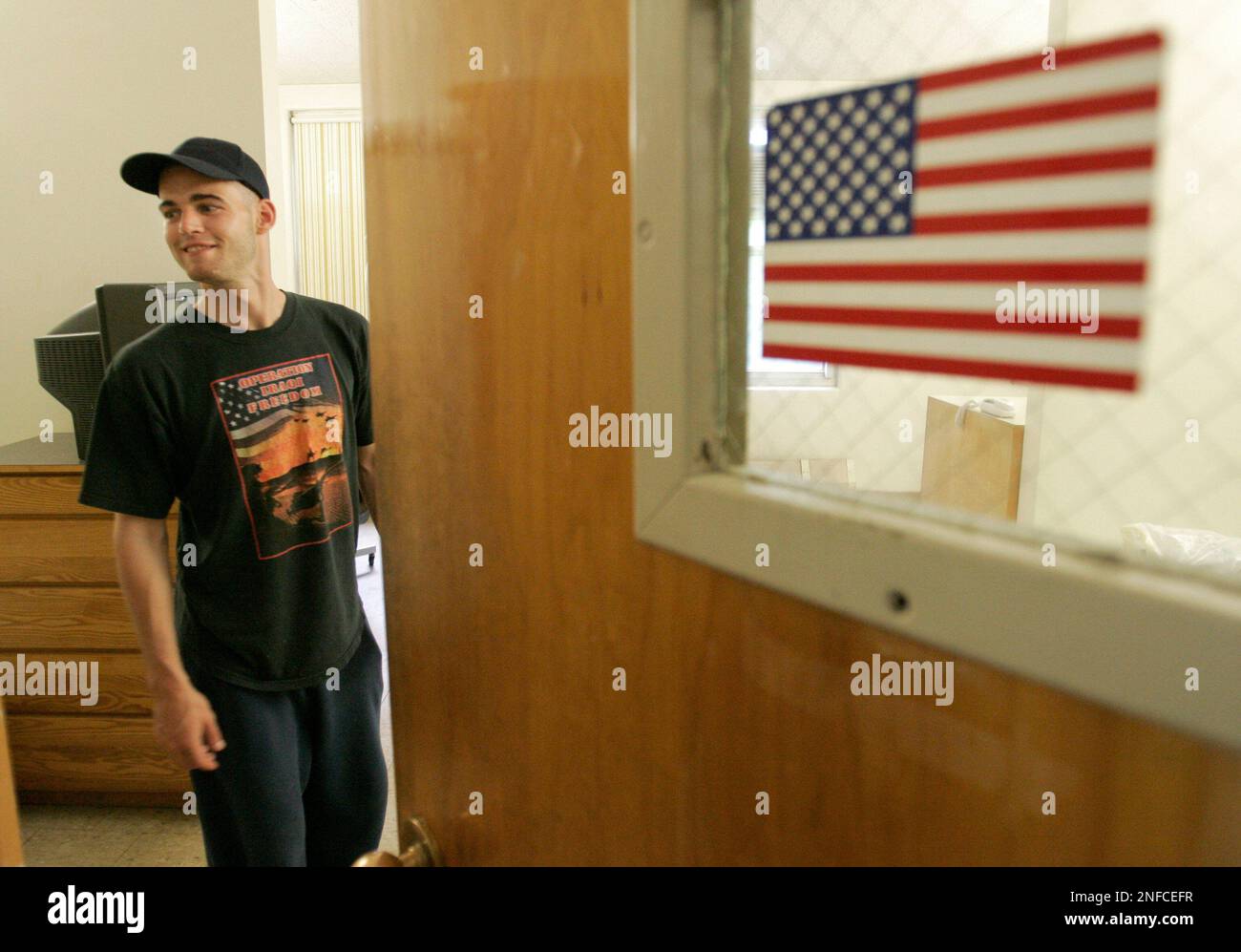 Iraq war combat veteran Andrew Cotrel stands in the doorway of his ...