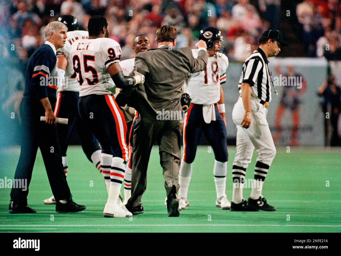 Chicago Bears coach Mike Ditka is restrained by defensive end Richard ...