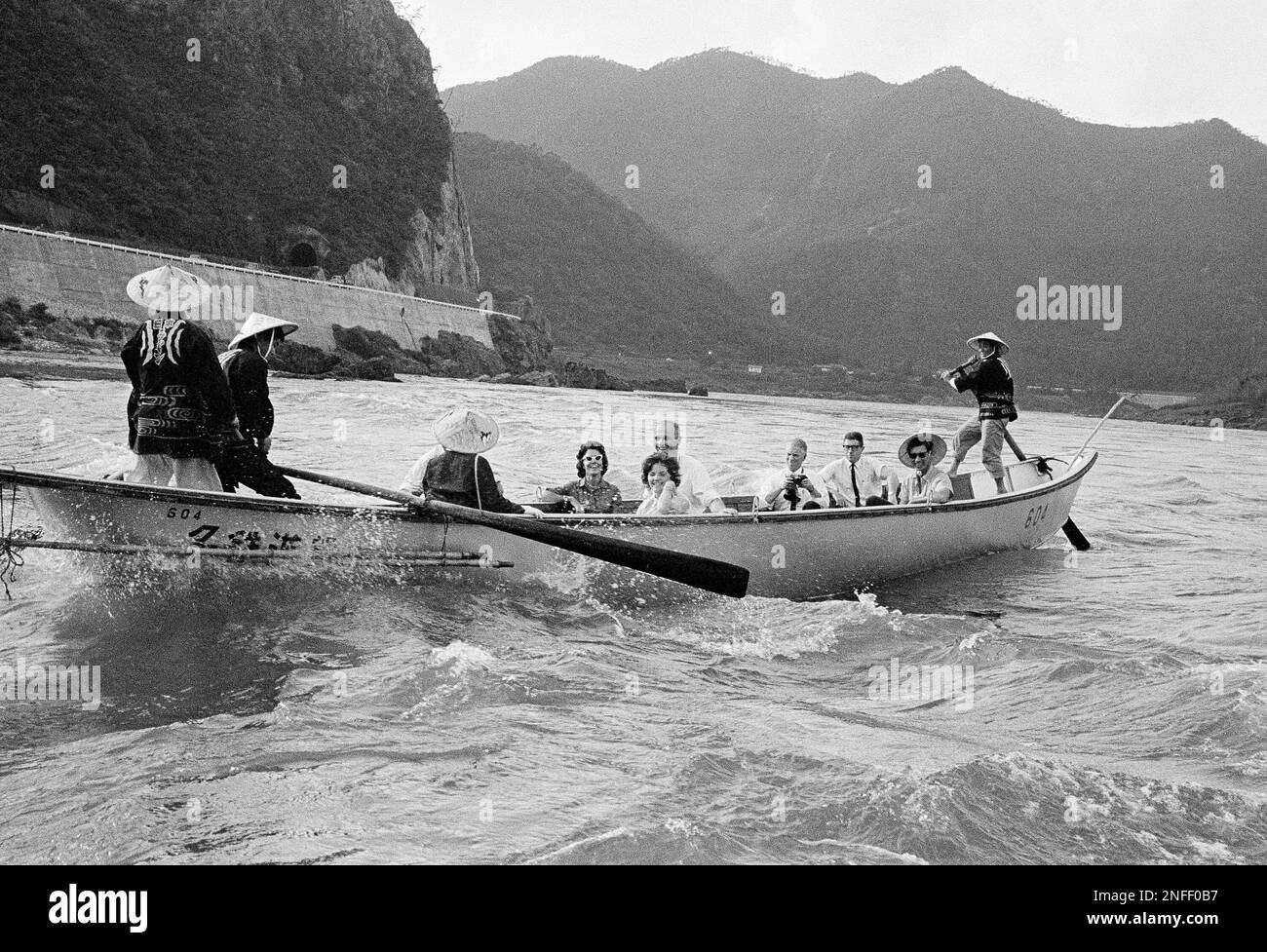 Astronaut John Glenn and his family, vacationing in Japan, shoot the rapids on the Kiso River ...
