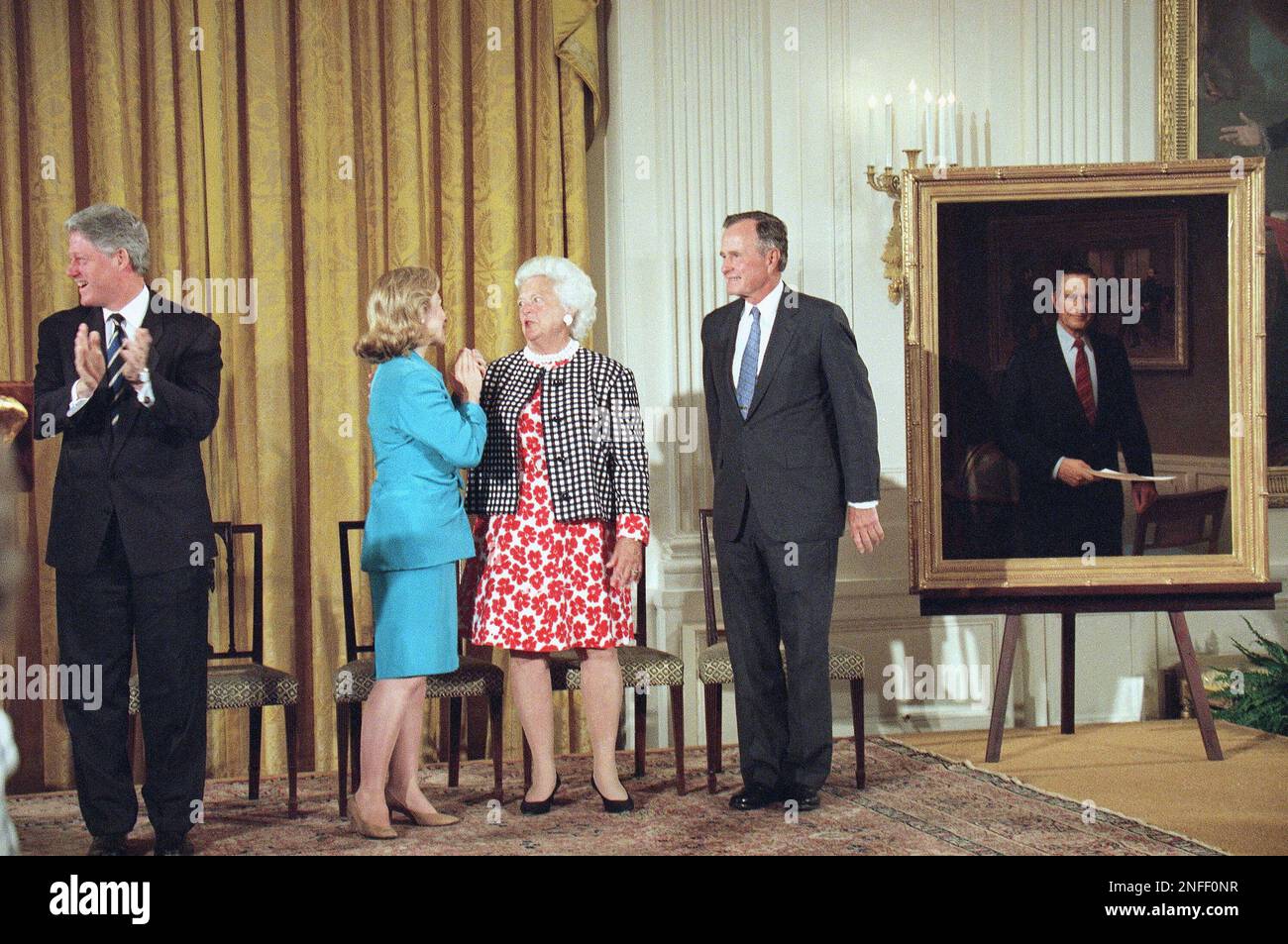 President Bill Clinton, left, and first lady Hillary Rodham Clinton, second from left, applaud ...