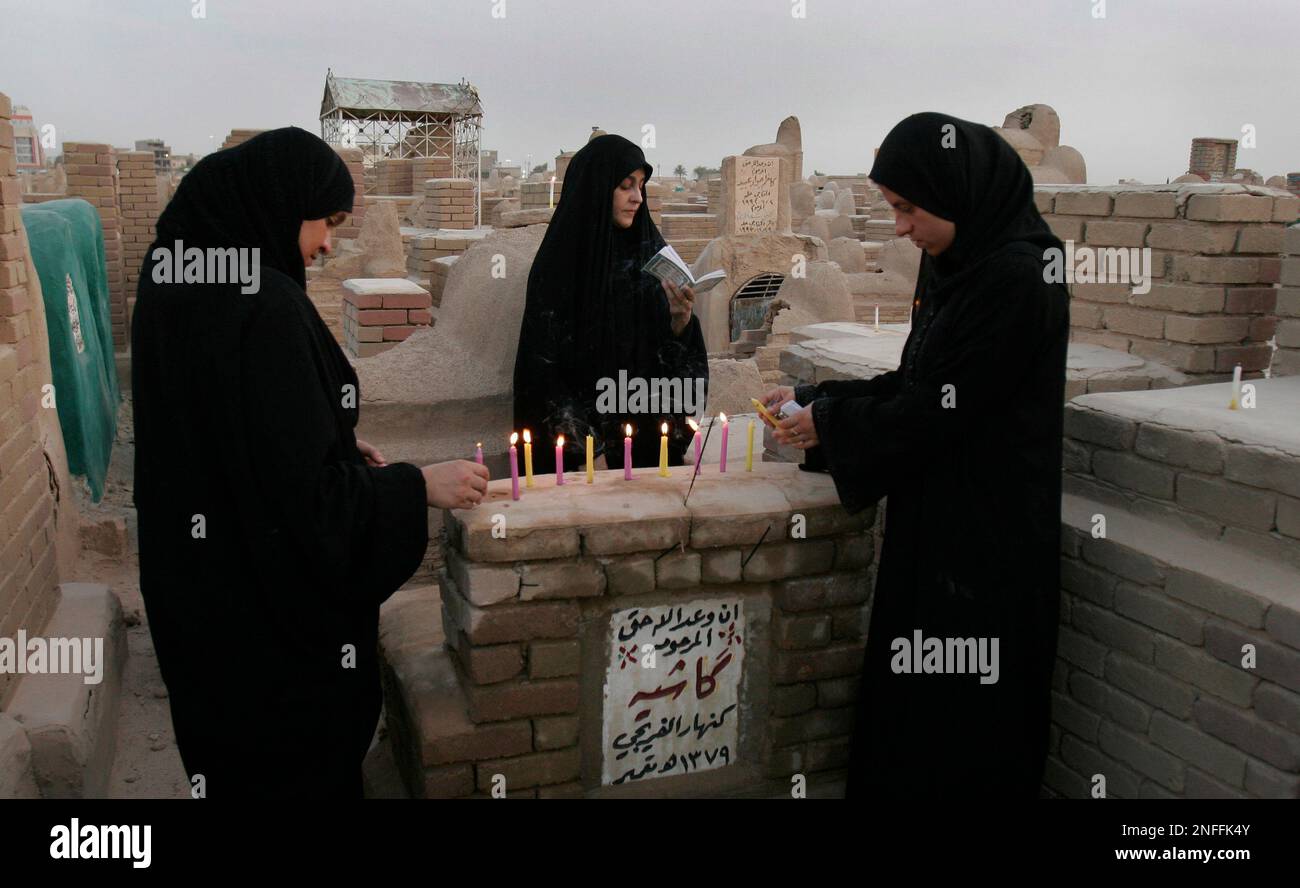 Relatives light candles and recite verses of the Holy Quran as they pay ...