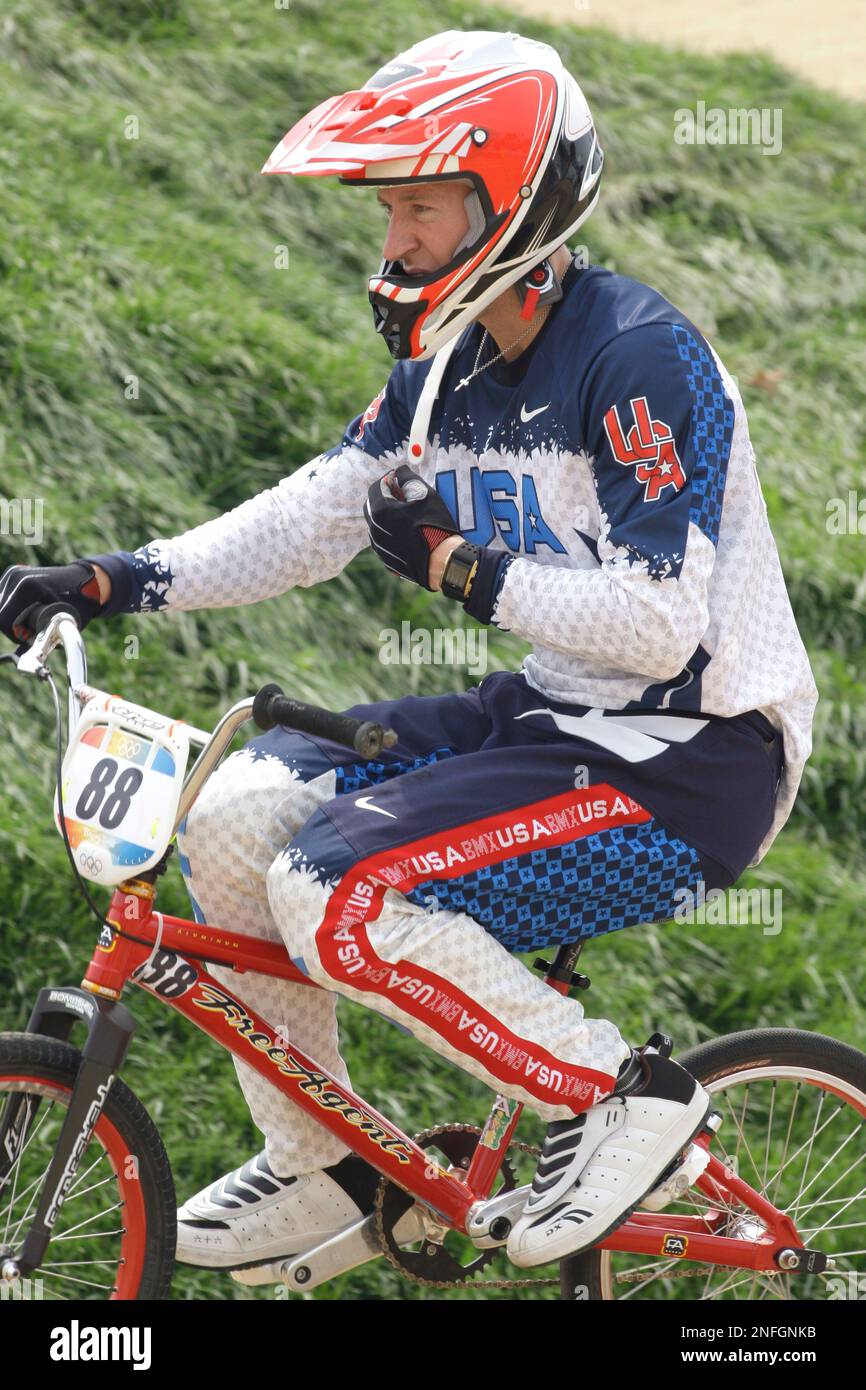 Kyle Bennett, of the United States, holds his left arm in pain as he ...