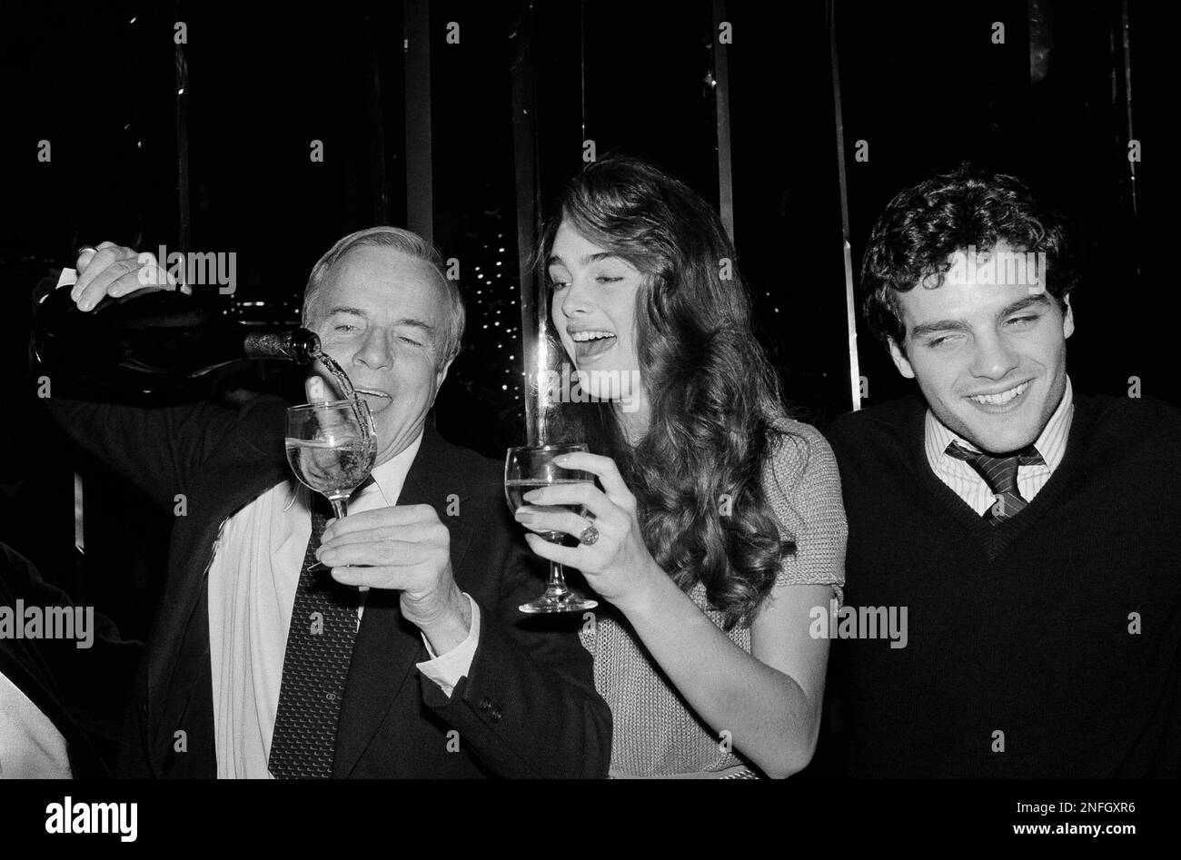 Director Franco Zeffirelli pours some celebrational champagne into his ...