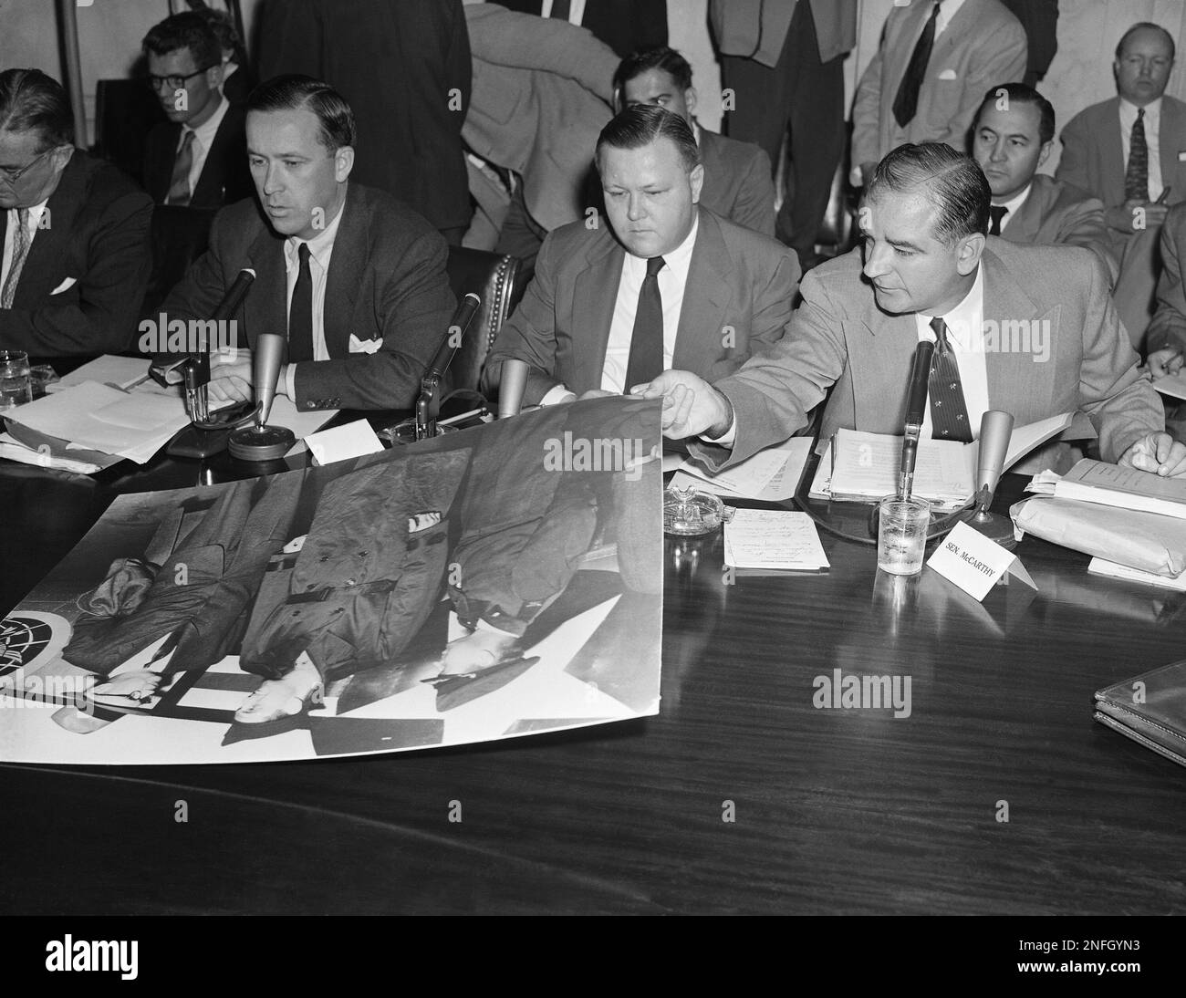 Sen. Joseph McCarthy (R-Wisc.) holds a photo by one corner during a ...