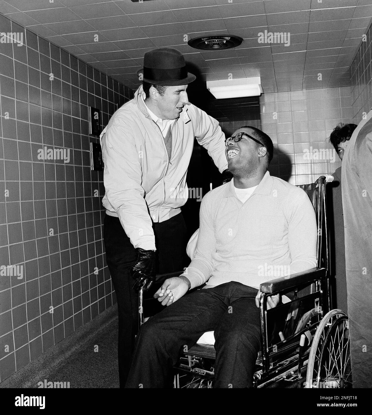 Maurice Stokes,right, former Cincinnati star in the NBA, who was ...